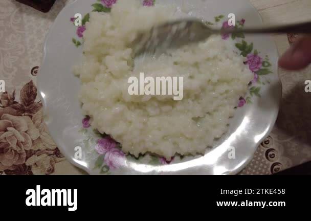 rice porridge on a plate. boiled rice. man eats rice. High quality 4k ...