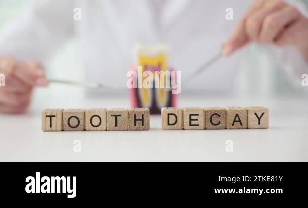 Word tooth decay and dentist with tooth in dental clinic. Treatment and ...