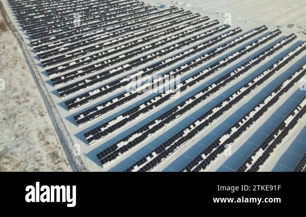 Aerial view of snow melting from covered solar photovoltaic panels at ...