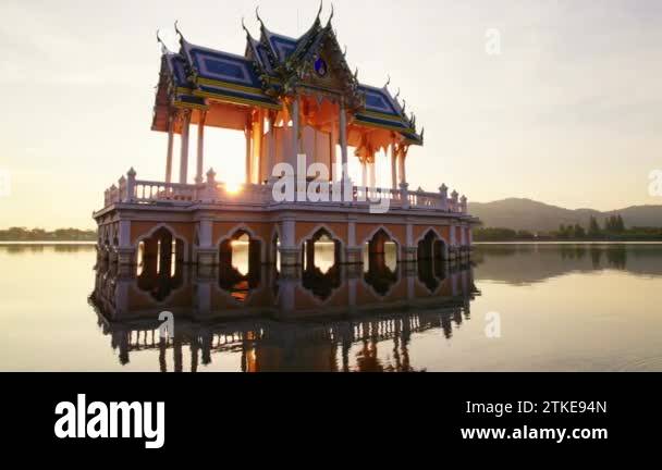 Drone arc shot from right to left of the Khao Tao lake temple up close ...