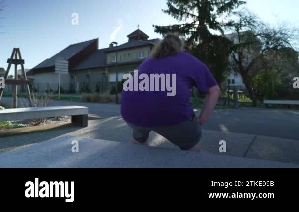 One overweight man suffering from back pain outside. A fat guy having ...