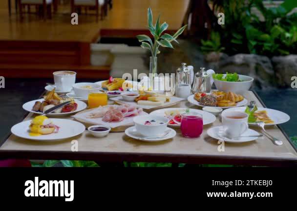 Hotel breakfast setting - coffee, fresh orange juice, eggs on table in ...