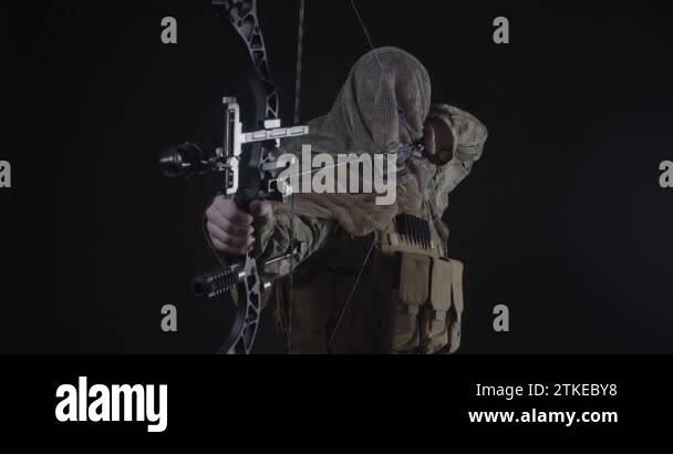 Silent killer - an archer in a military uniform and a futuristic mask ...