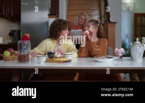 Pretty girl and cute boy talking eating delicious sweet snack in the ...