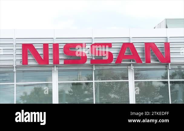 nissan red logo sign exterior outside outdoors on front of dealership ...