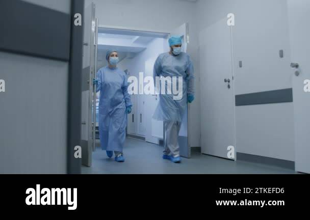 Nurse and paramedic open medical facility corridor doors. Multi ethnic ...