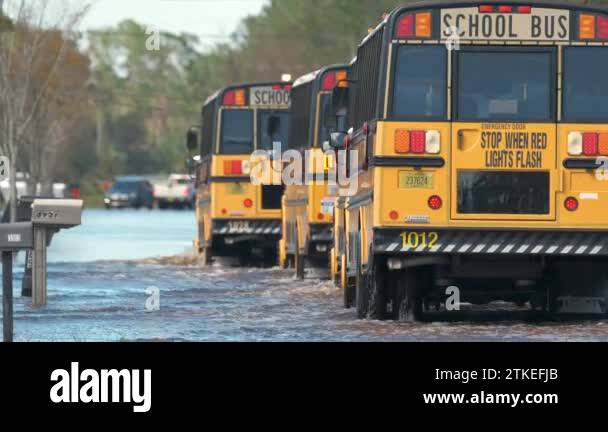 Hurricane Ian flooded street with moving evacuation school buses in ...
