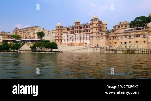 Udaipur City Palace view from moving boat on lake Pichola. Luxury white ...