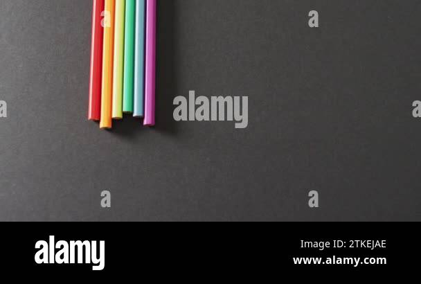 Video of rainbow straws over grey background with copy space. Gender ...