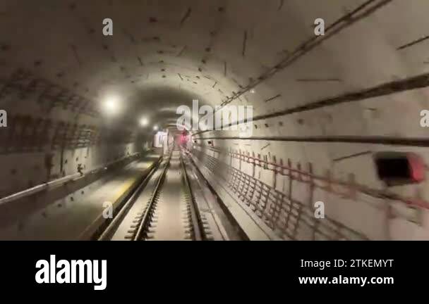 Train rear view in a subway tunnel. Singapore MRT train in a subway ...