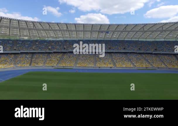 Flying inside huge modern empty stadium. Movement along the fan sectors ...