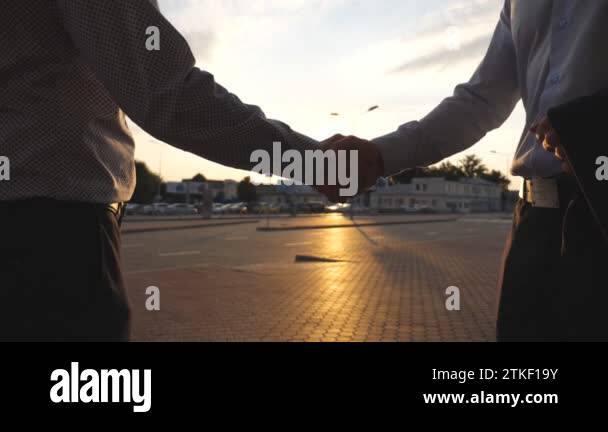 Two businessmen meeting and greeting each other in urban environment ...