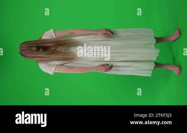 Full-size vertical green screen, chroma key video of a posessed female ...