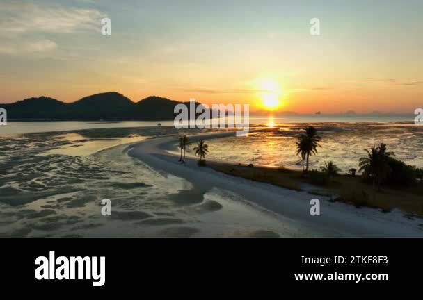 Amazing sandy beach in golden sunrise.A sandbar stretches down into the ...