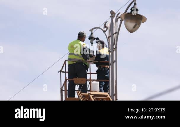 diode lights, Municipal worker, led lights. Workmen working on ...