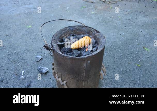 Grilled corn cobs on coal stove.Fresh roasted corncobs on coal fire ...