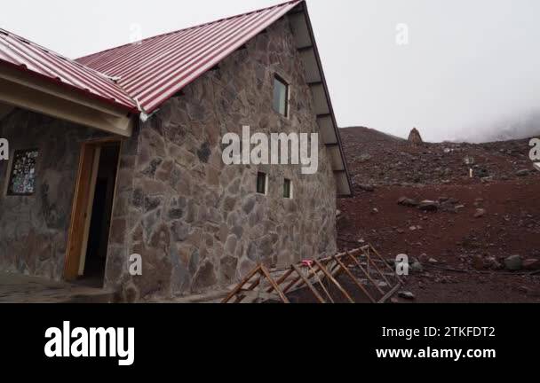 mountain hut, or refuge at the mighty Chimborazo is a snow capped and ...