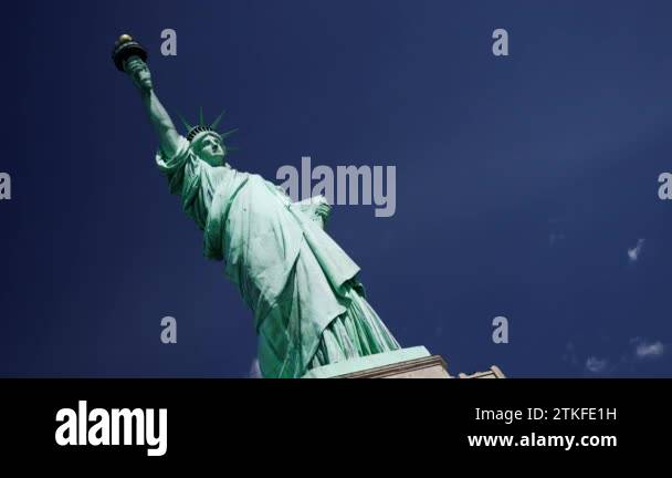 A low angle shot in spiral motion of the Statue Of Liberty located in ...