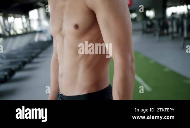 Cropped view on athletic shirtless male body with abs and obliques at ...