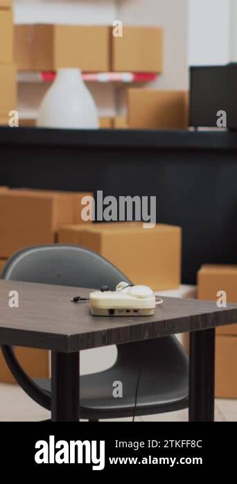 Vertical video: Empty storage room with office desk and shelves ...