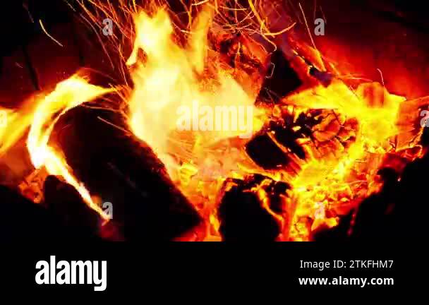 Live coals. Beautiful fire background. Hot red coals flare up in a fire ...