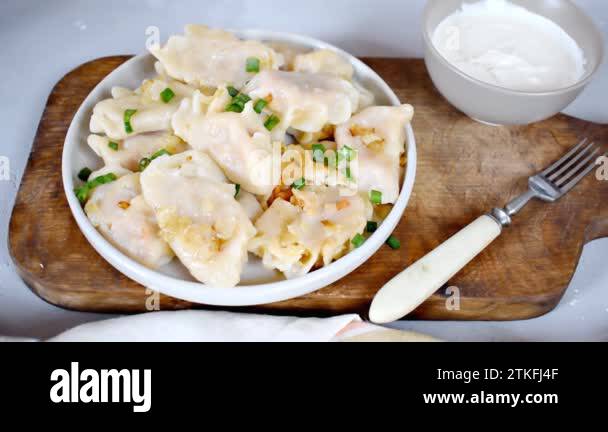 Homemade dumplings, vareniki, varenyky, pyrohy with stewed cabbage ...