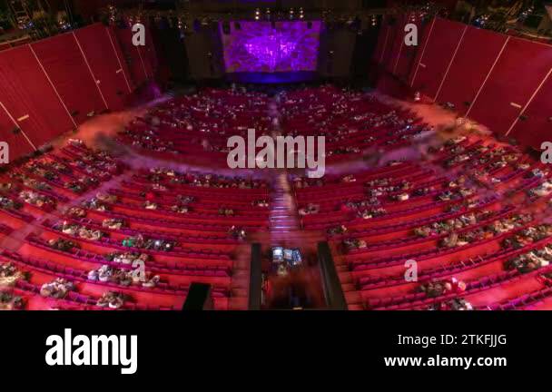 Spectators gather in the auditorium and watch the show in theatre ...