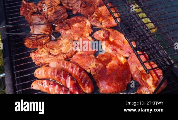Using tongs, the grill staff turns the pieces of meat to the other side ...