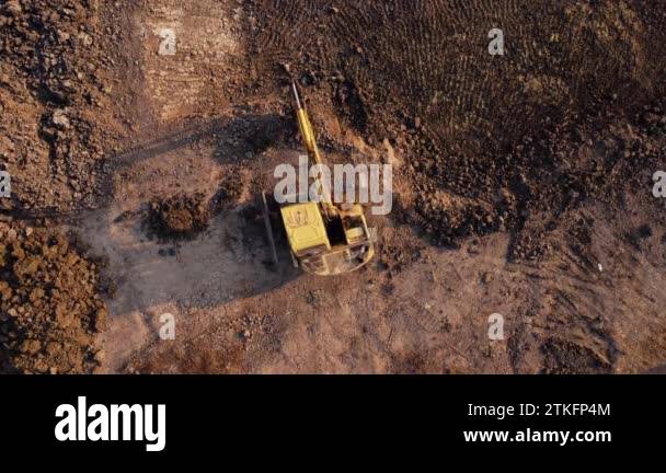 Excavator dig ground at construction site. Aerial view of a wheel ...