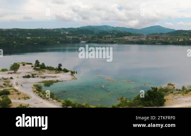 Mining quarry with flooded bottom. Lake with blue water near sand pit ...