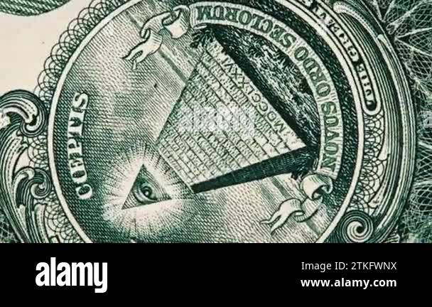 The all-seeing eye sign rotates on a one dollar bill close-up. Mason ...