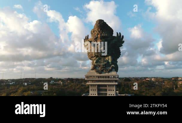 Drone Aerial view 4k Statue of Vishnu in Garuda Wisnu Kencana Cultural Park at sunrise. Bali's ...