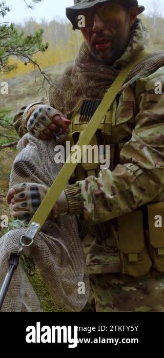 Wounded mercenary soldier with a blood on the face looking at camera ...