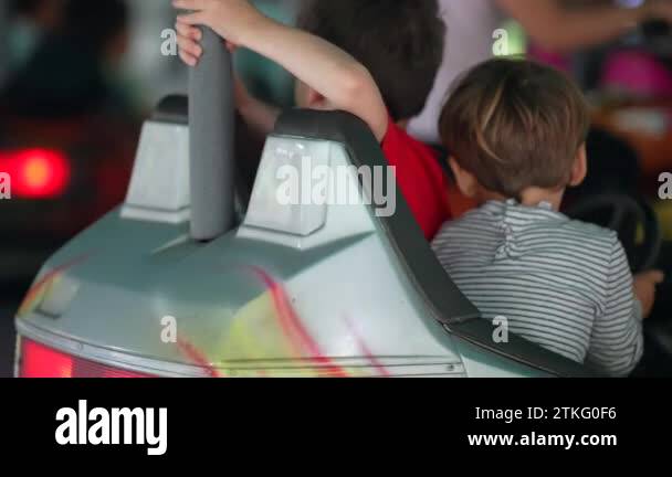 Children having fun at bumper car at the fun fair. little boy driving ...