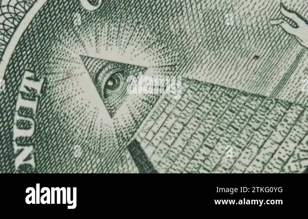 The all-seeing eye sign rotates on a one dollar bill close-up. Mason ...