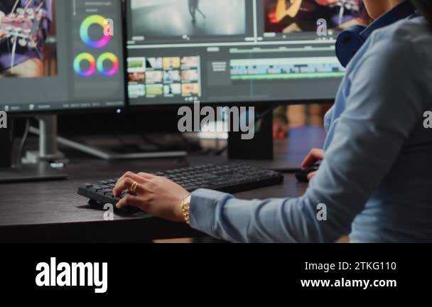 Young content creator editing video and audio montage on computers ...