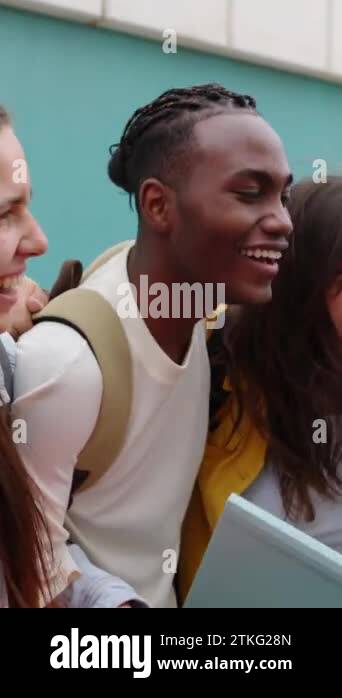 Happy diverse group of student friends laughing together at college ...