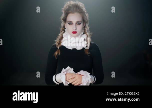 Medium shot portrait of young Caucasian actress in costume imitating ...