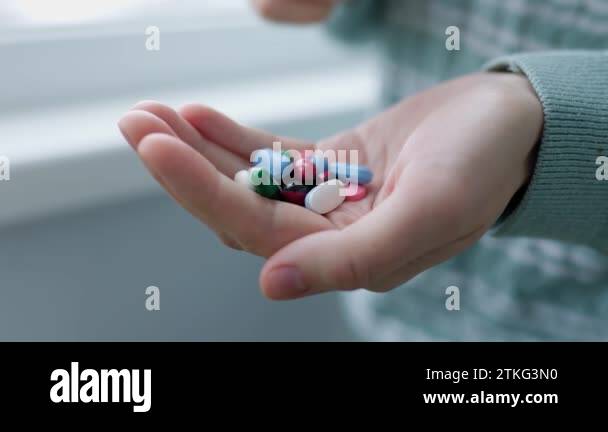 Woman hand taking out white pill into the palm from the her palm. Girl ...