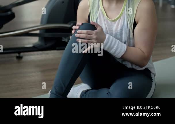 Young woman feel pain from knee muscle injury while exercising in ...