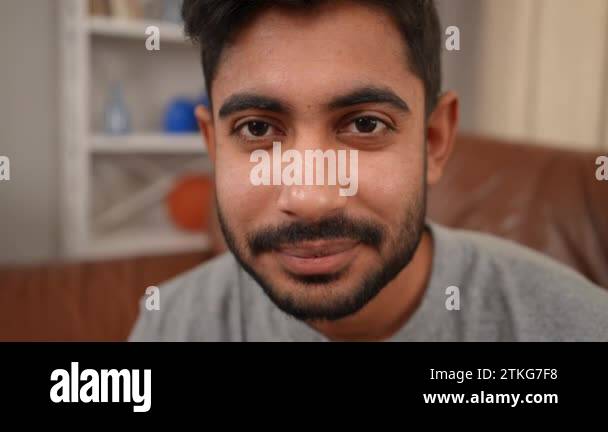 Headshot portrait of positive young man raising face looking at camera ...