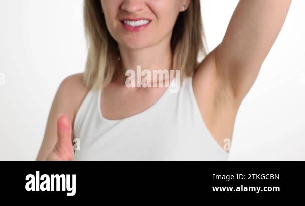 Woman shows smooth armpit with thumb up. Recommendations and approval ...