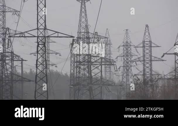 Many tall metal high-voltage towers with electrical wires against the ...