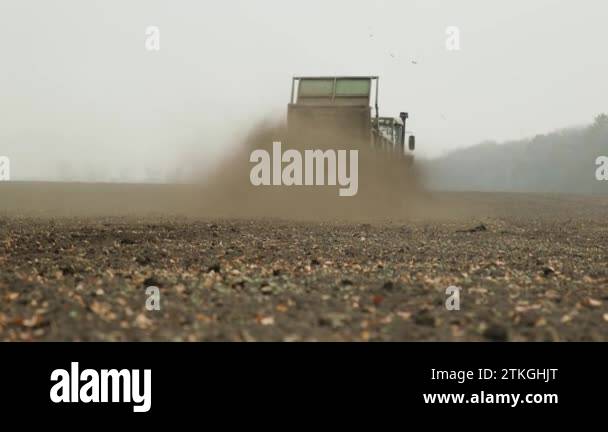 Fertilizing fields with compost. Fertilization of earth with organic ...