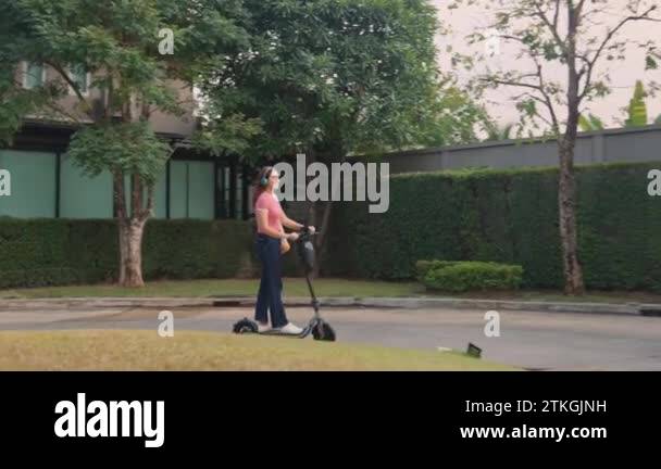 Young woman happy smile girl go green asia people ride EV bike push ...