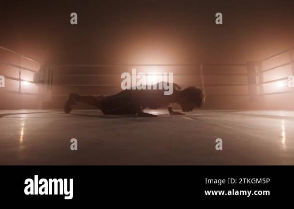 Portrait of a male athlete performing push-ups to stimulate muscle ...
