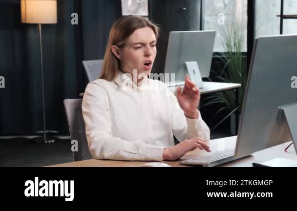 Unhappy Business Woman Office Worker Sitting at a table with a Computer ...
