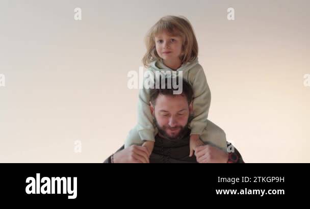 Portrait of a happy handsome dad with his son in his arms. Happy fairy ...