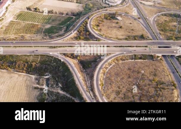 Top view to the cars driving on multi-level highway on the sunset ...