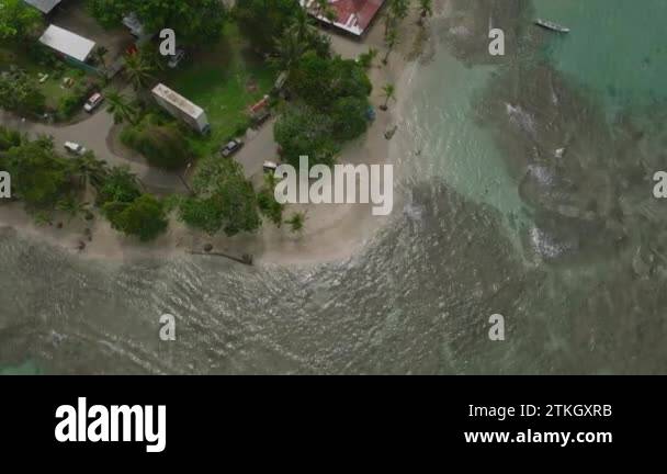Top down ascending footage of rippled crystal clear sea water along ...